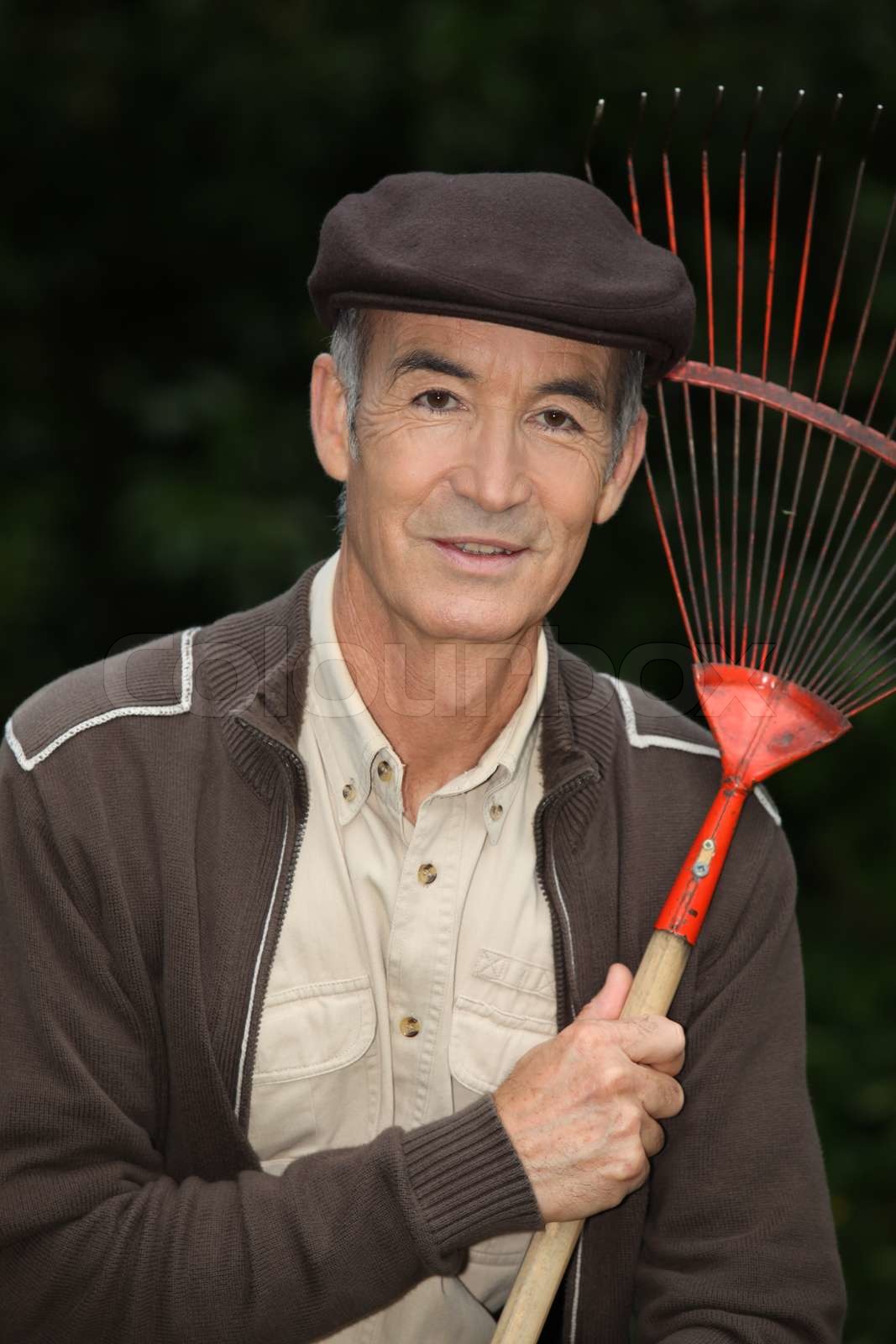 Man with rake | Stock image | Colourbox