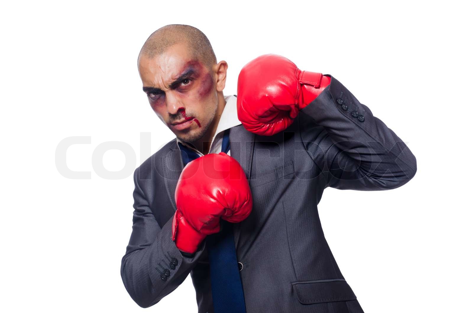 Badly beaten businessman with boxing gloves | Stock image | Colourbox