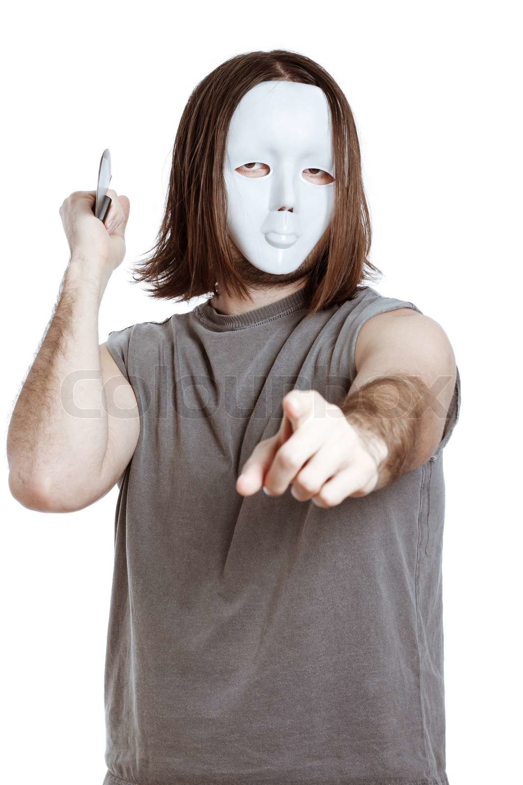 Scary masked man with knife pointing | Stock image | Colourbox