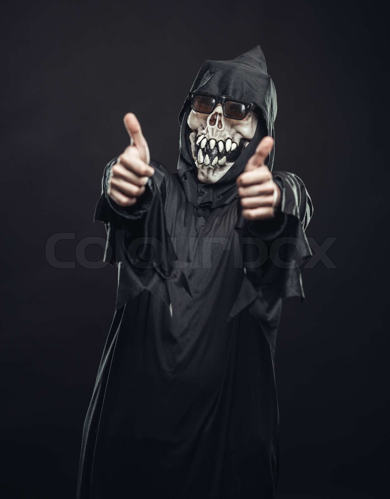 skeleton in a robe showing thumbs up | Stock image | Colourbox