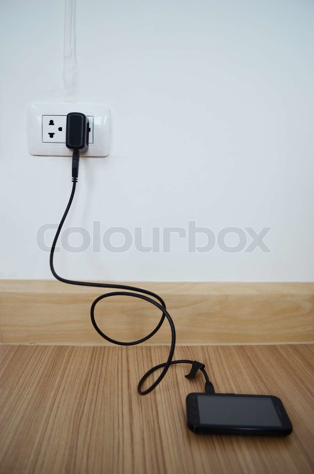 mobile phone and charger | Stock image | Colourbox