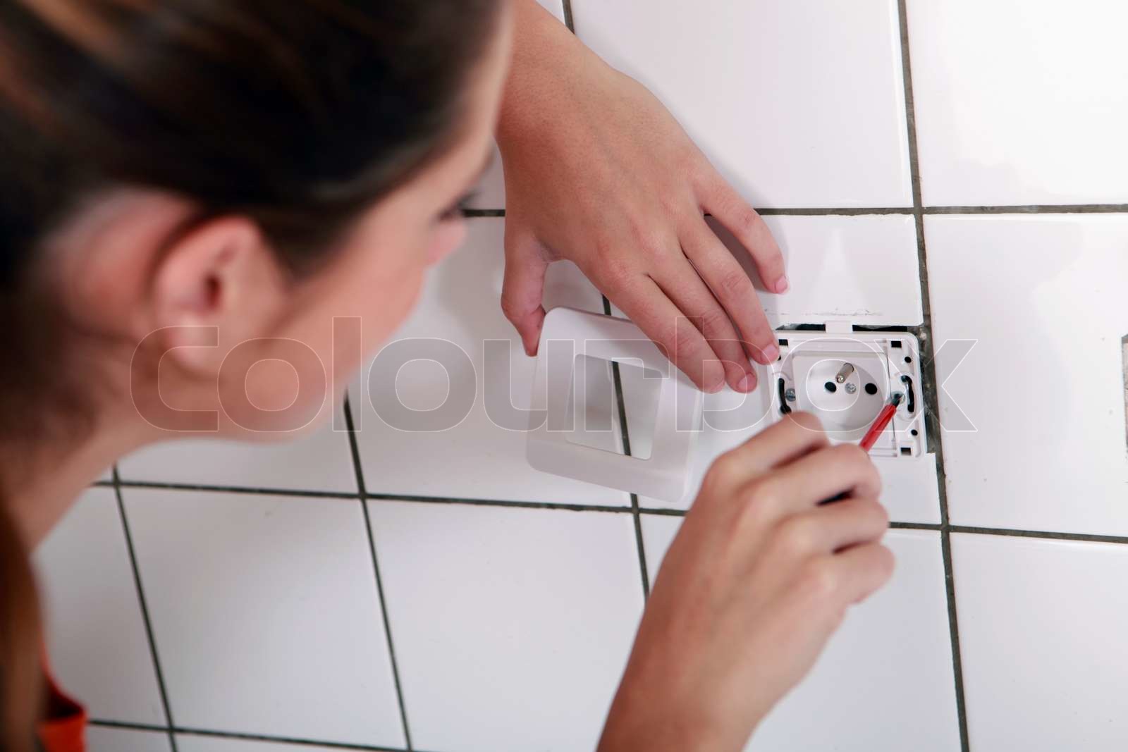 Woman fixing an outlet | Stock image | Colourbox