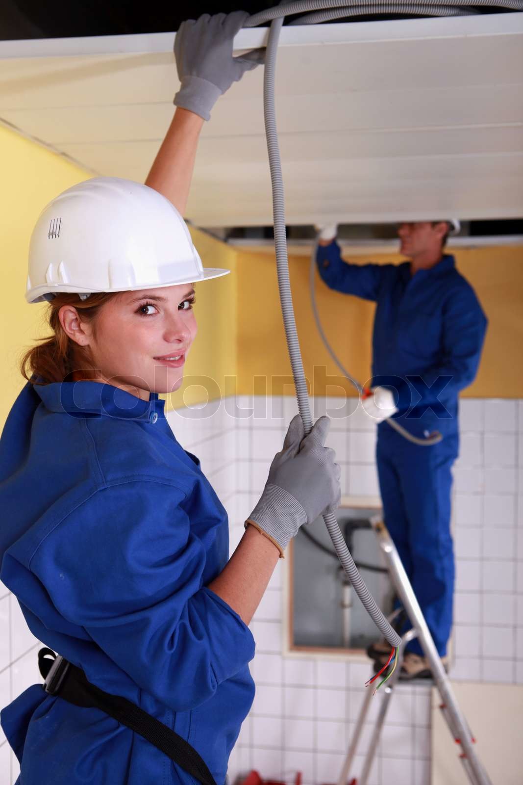 female plumber apprentice and tutor at work | Stock image | Colourbox