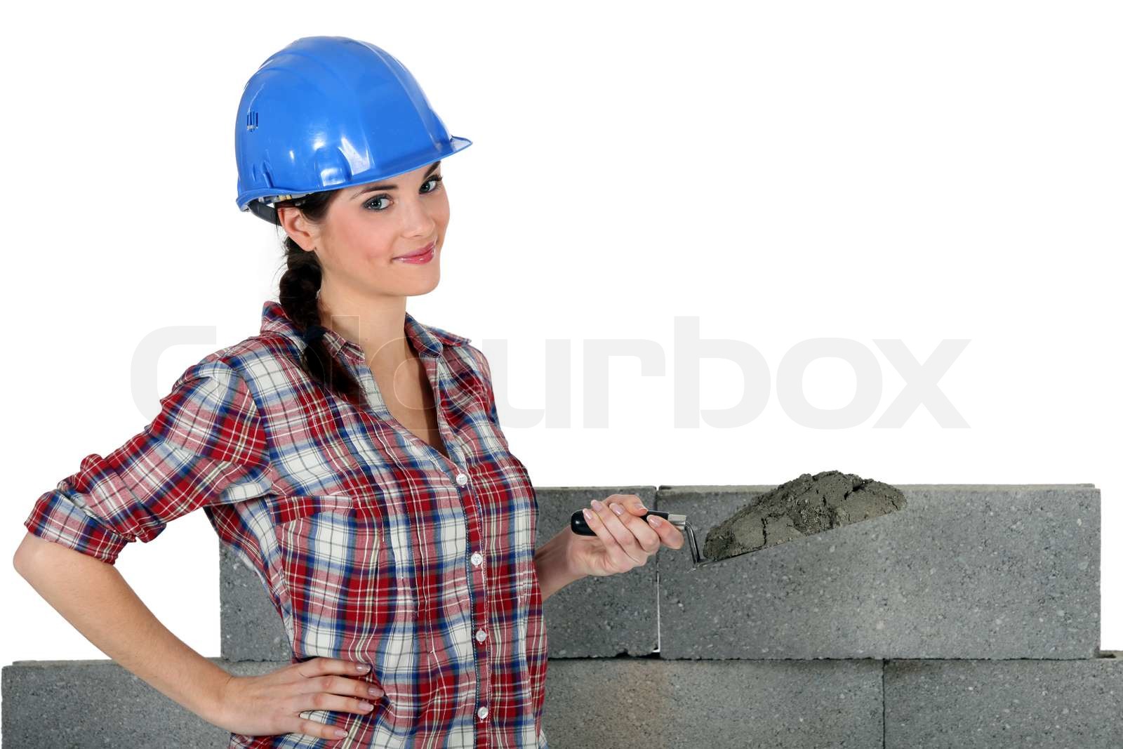 female mason applying cement | Stock image | Colourbox
