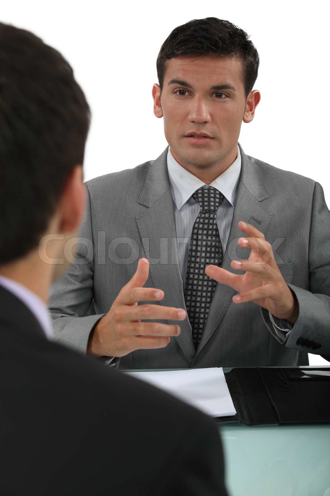 Businessman explaining something to a colleague | Stock image | Colourbox