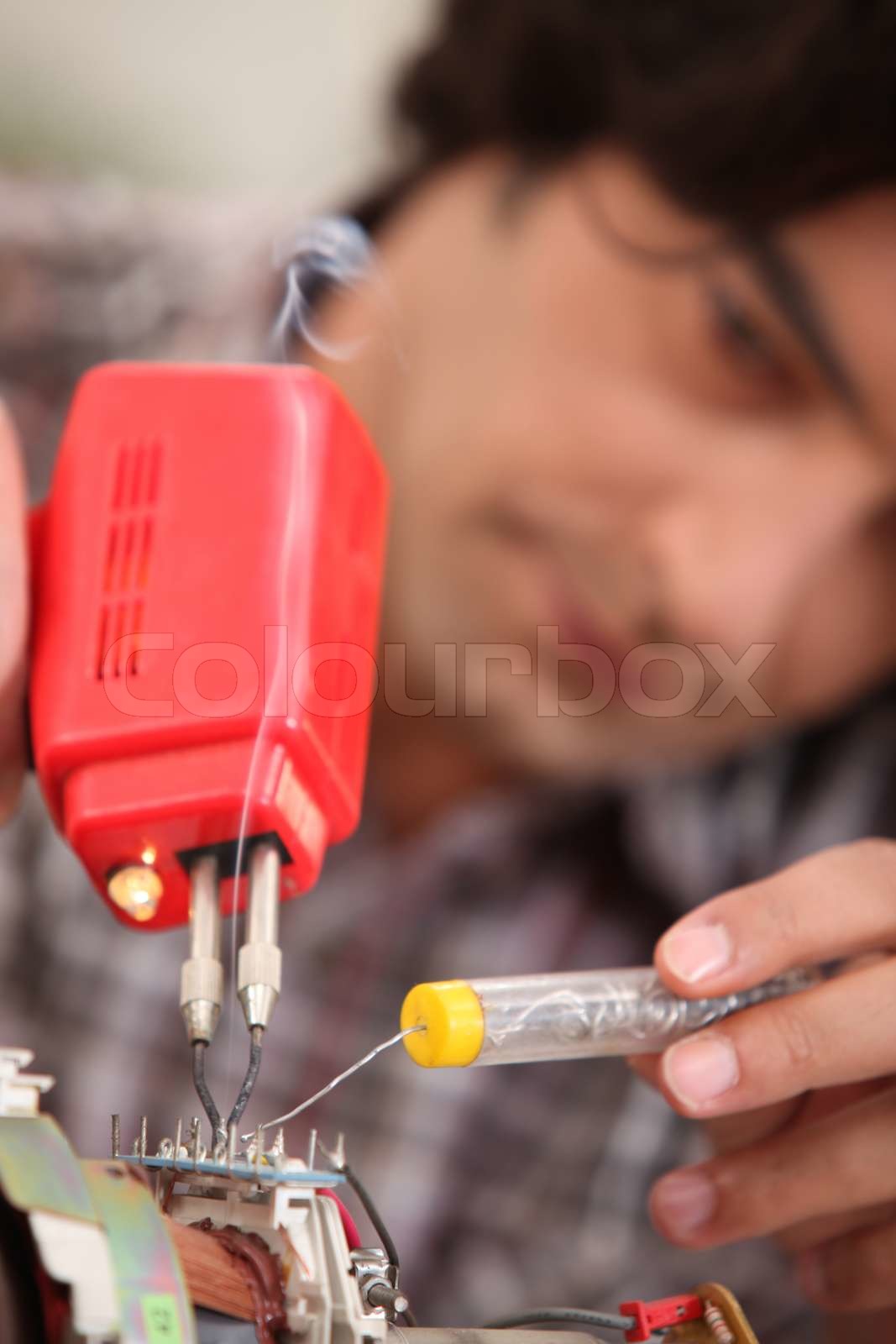 Man using soldering iron | Stock image | Colourbox