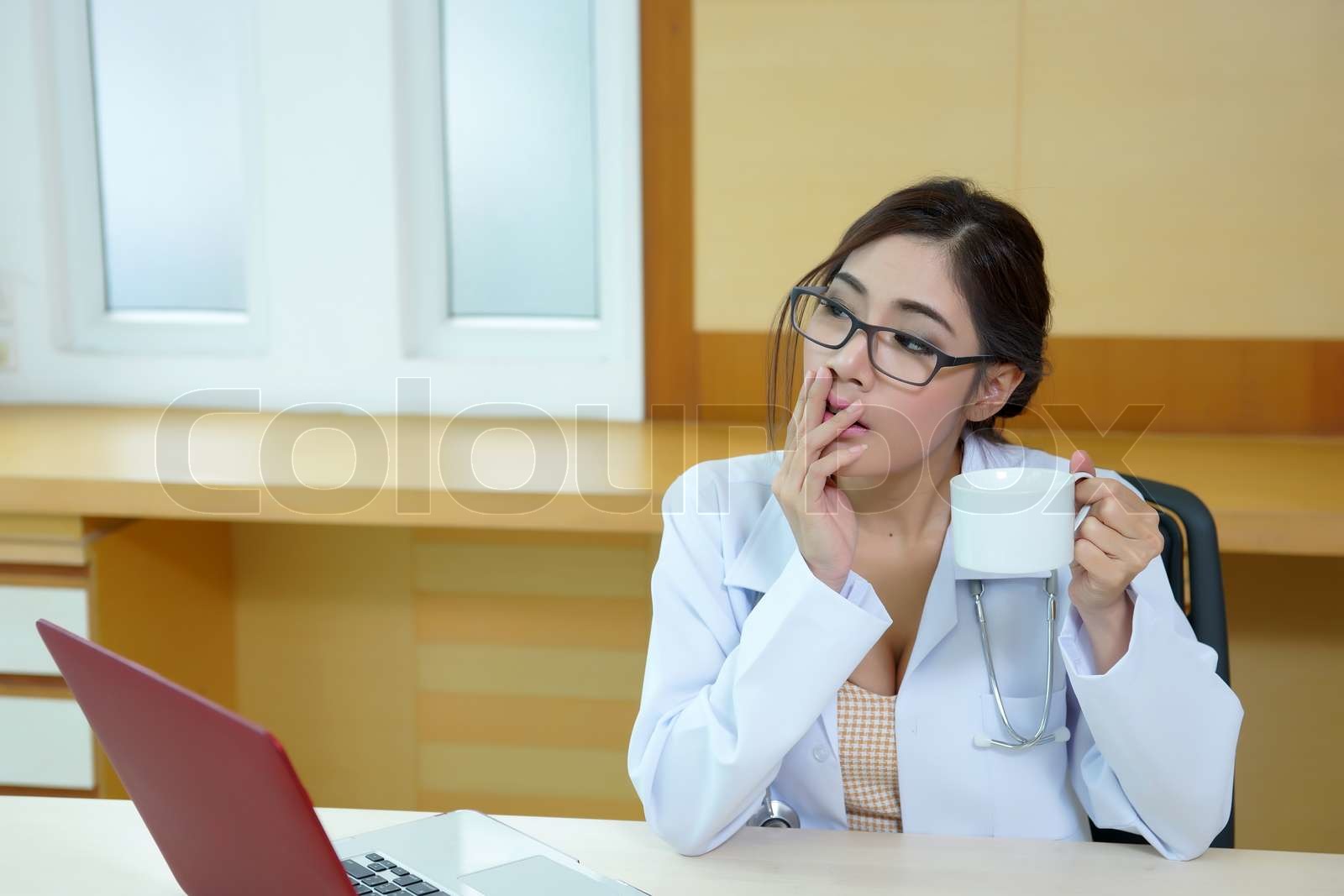 Female doctor had a very exhausting day at work | Stock image | Colourbox