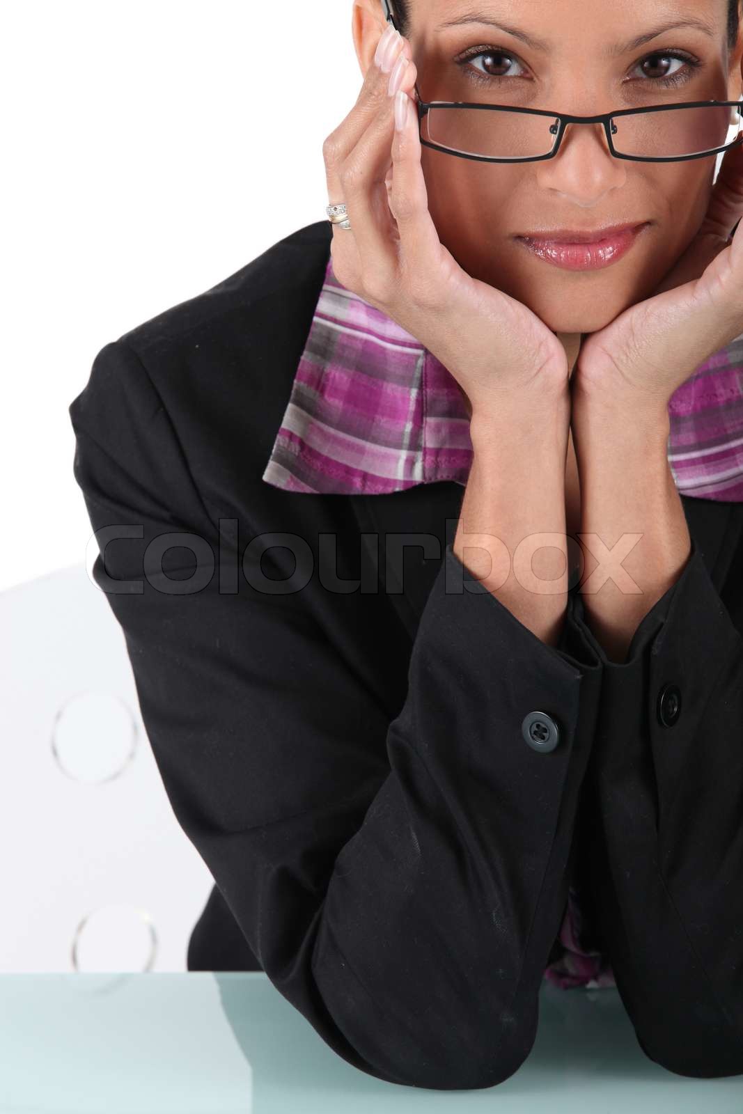 Woman peering over her glasses | Stock image | Colourbox