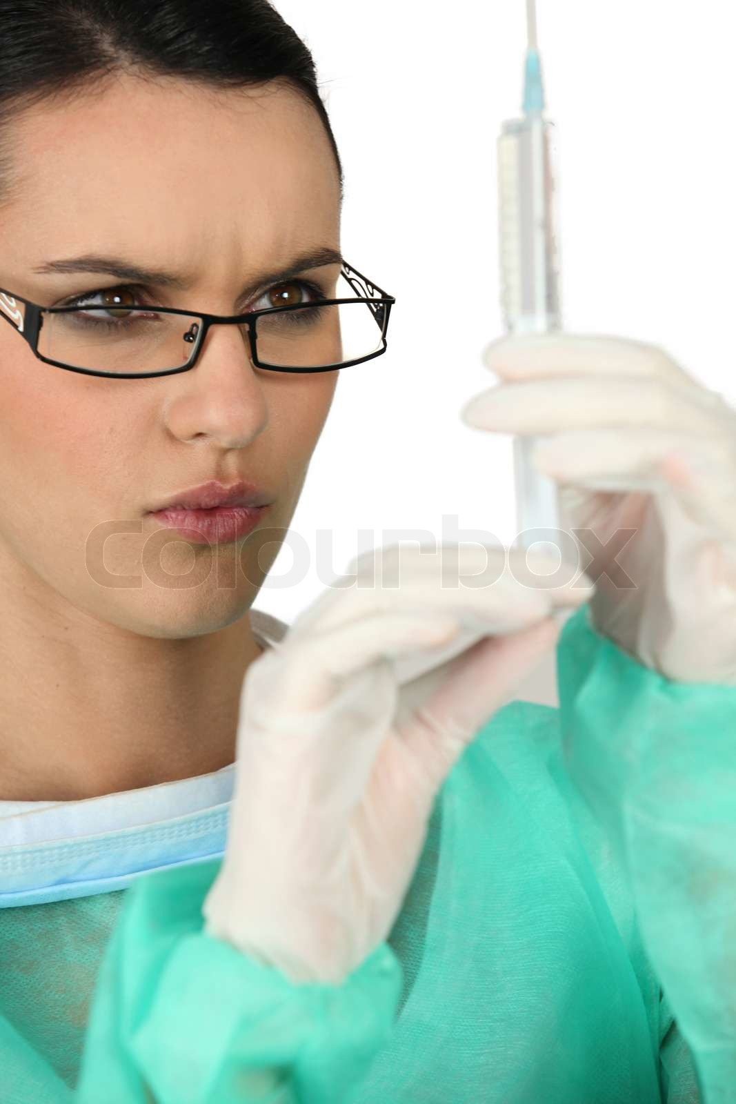 A medical professional preparing a needle | Stock image | Colourbox