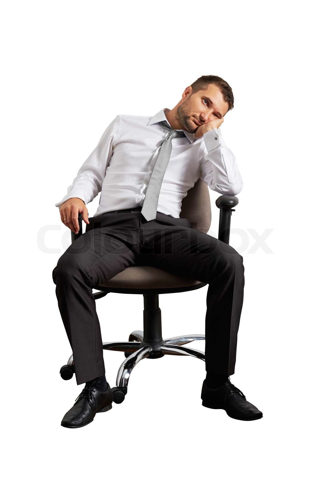 bored businessman sitting on the office chair | Stock image | Colourbox