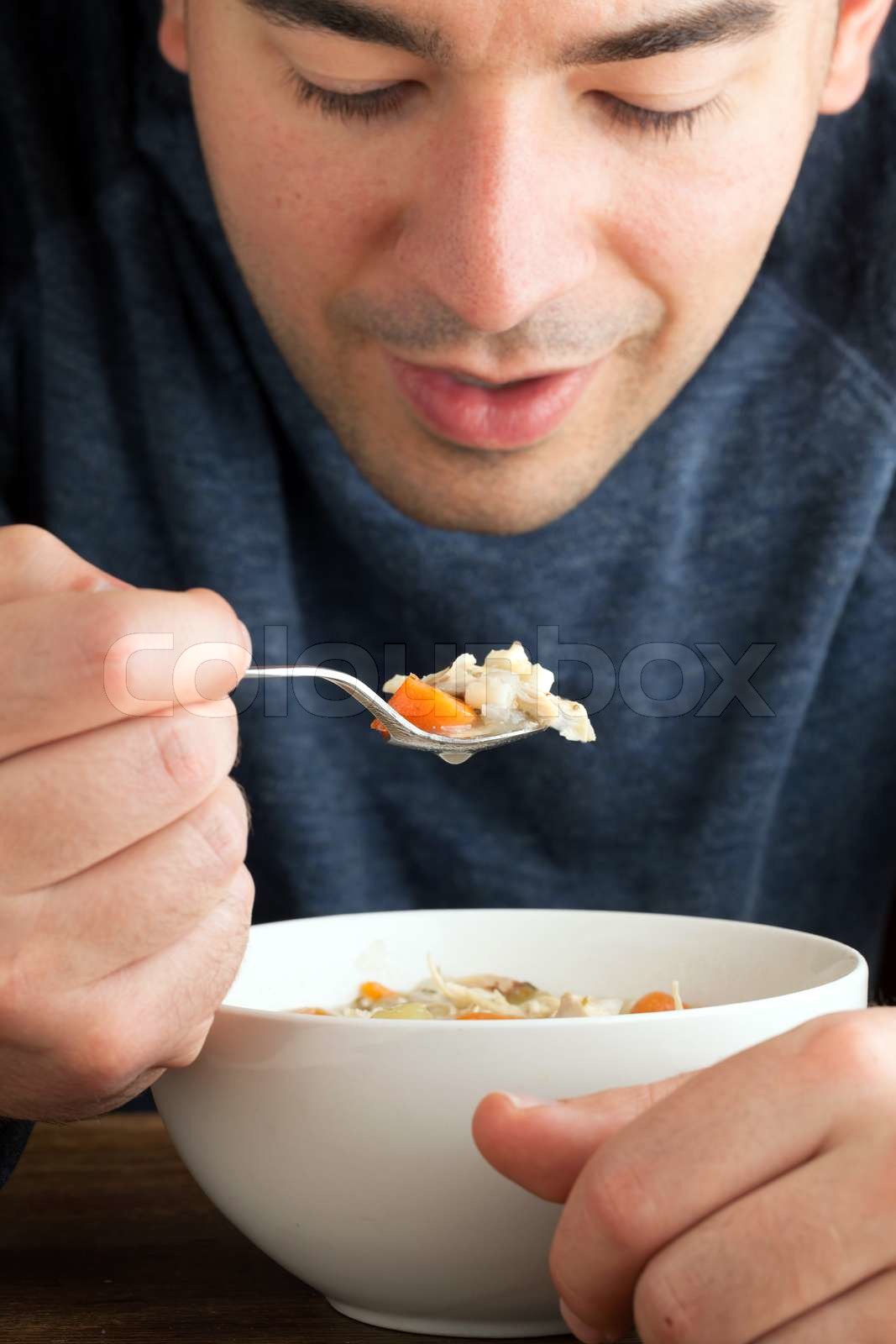 Man Eating Chicken Soup | Stock image | Colourbox