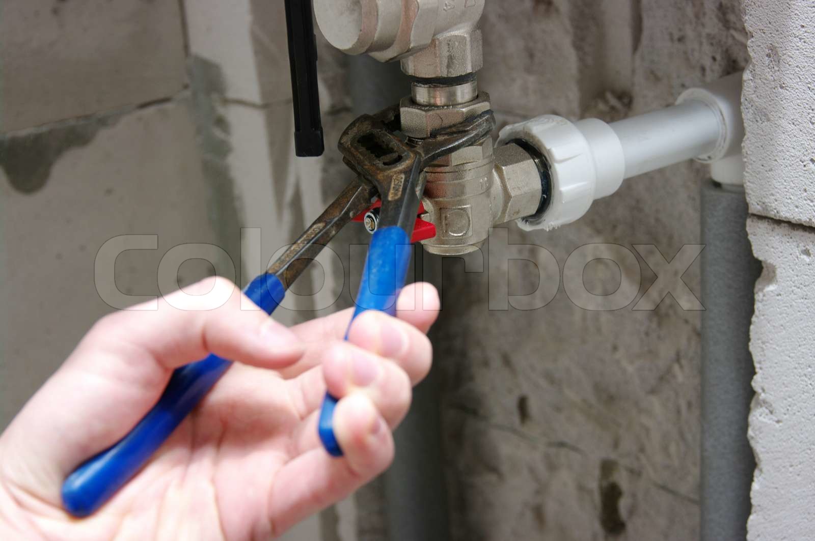 Plumber installing pipes | Stock image | Colourbox
