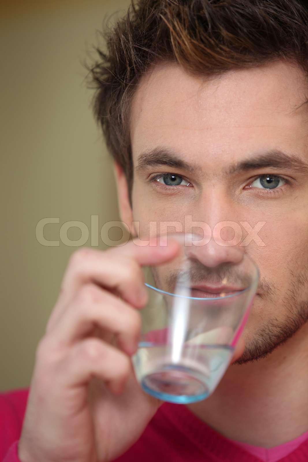 Man drinking from glass | Stock image | Colourbox