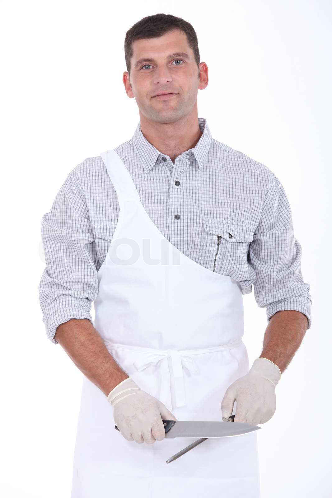 Butcher sharpening his knife | Stock image | Colourbox