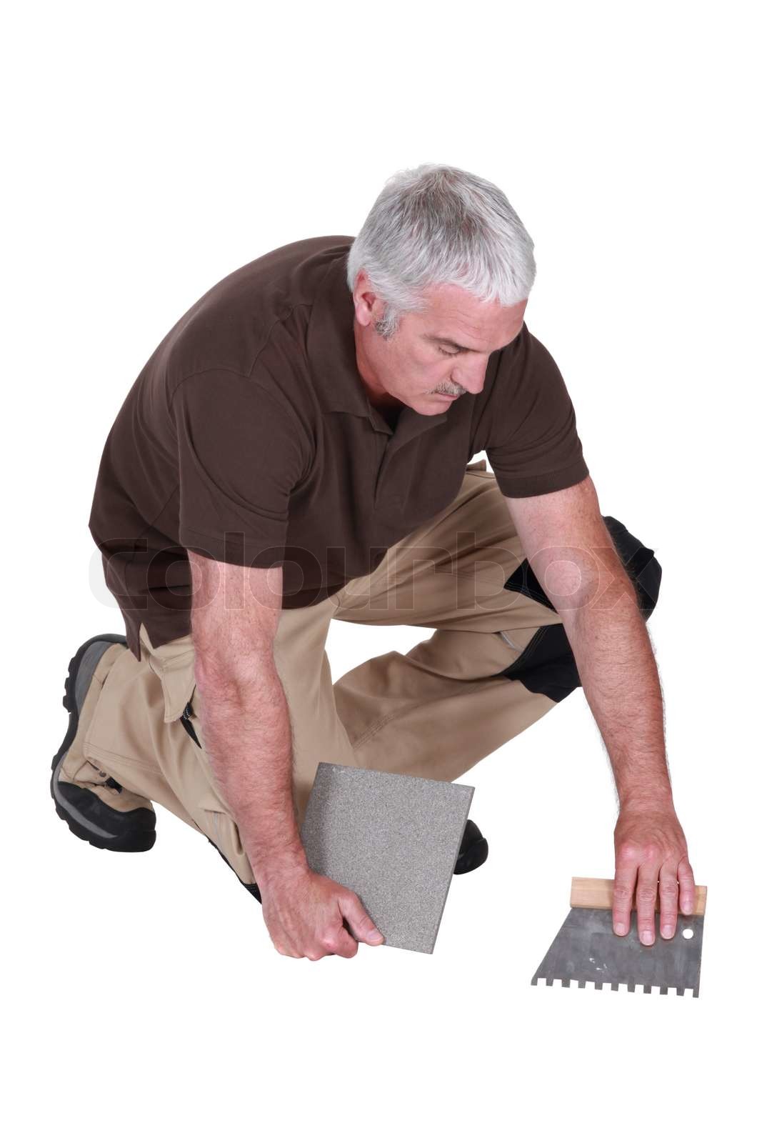 mature tiler at work | Stock image | Colourbox