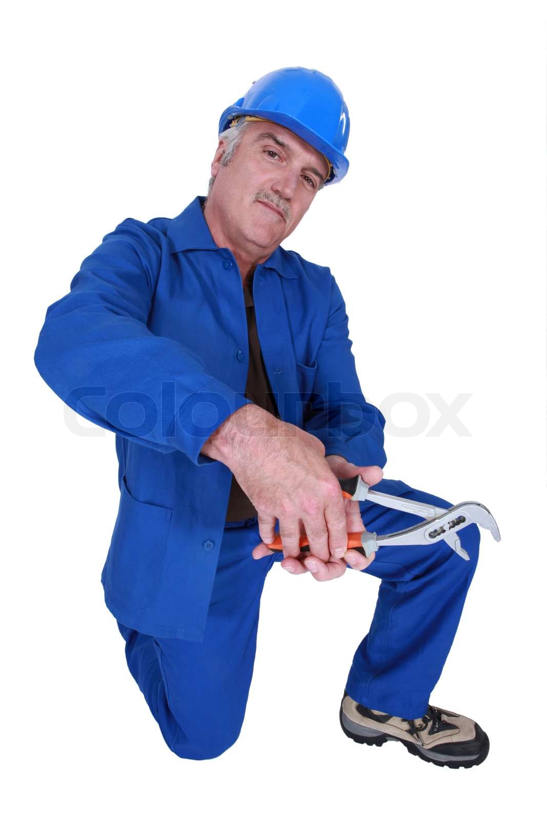 Workman with an adjustable spanner | Stock image | Colourbox