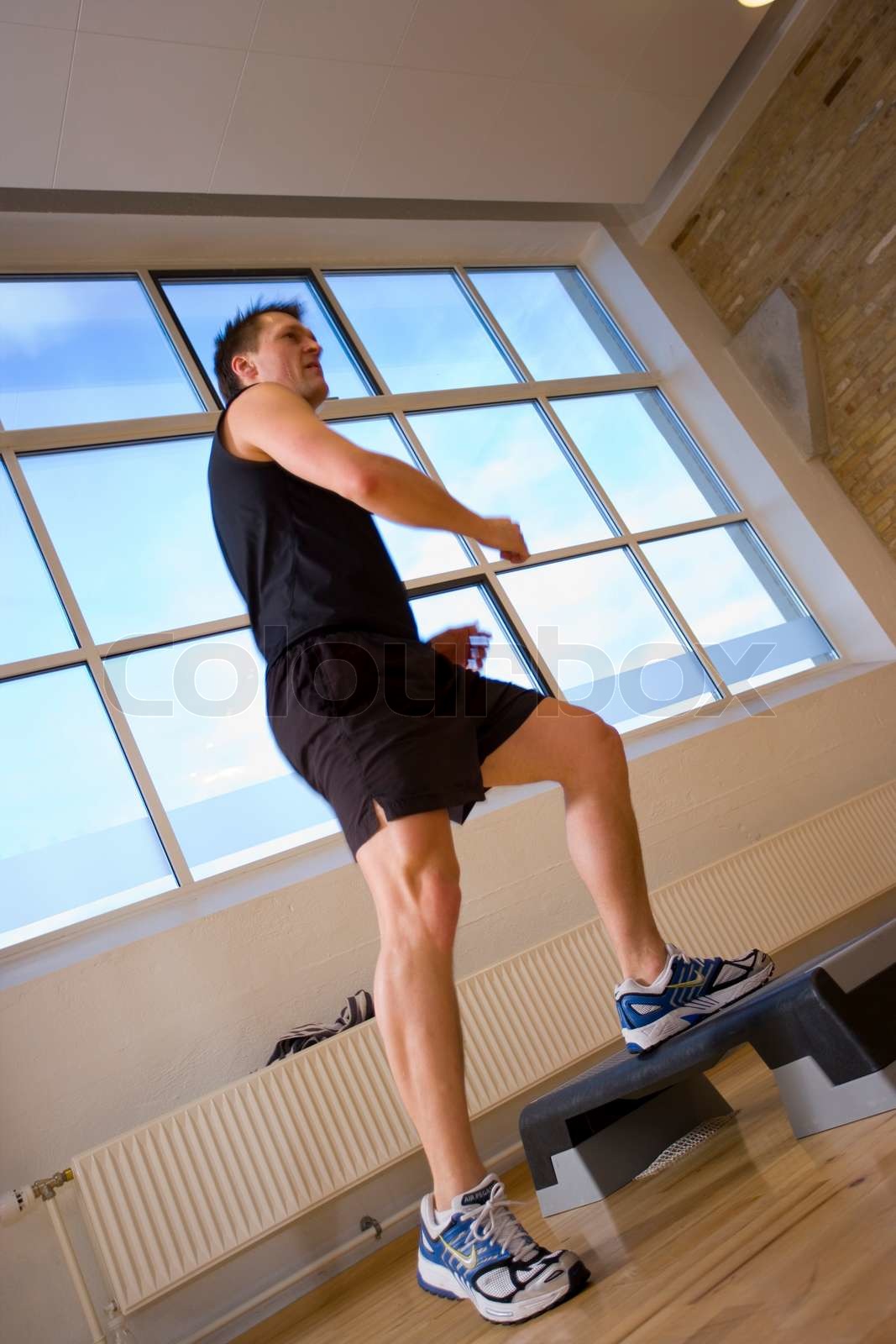 A male caucasian doing step aerobics | Stock image | Colourbox