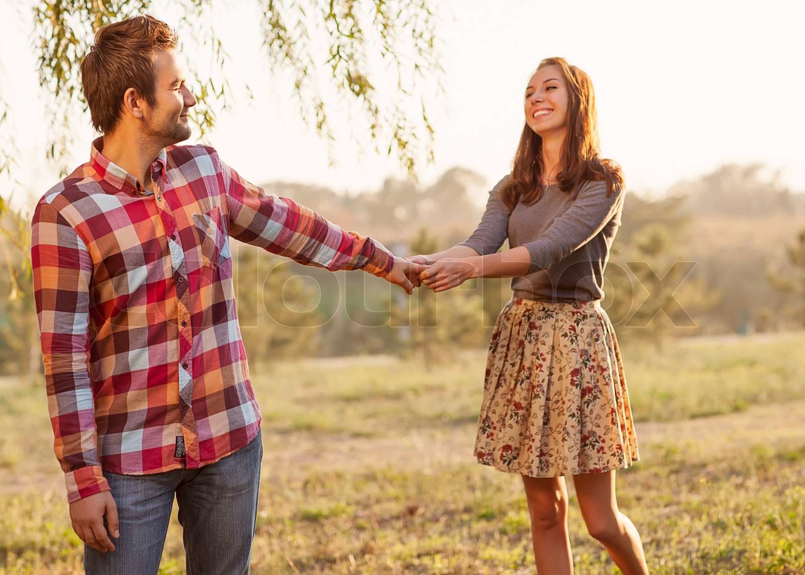 Young happy attractive couple walking together, outdoors | Stock image ...
