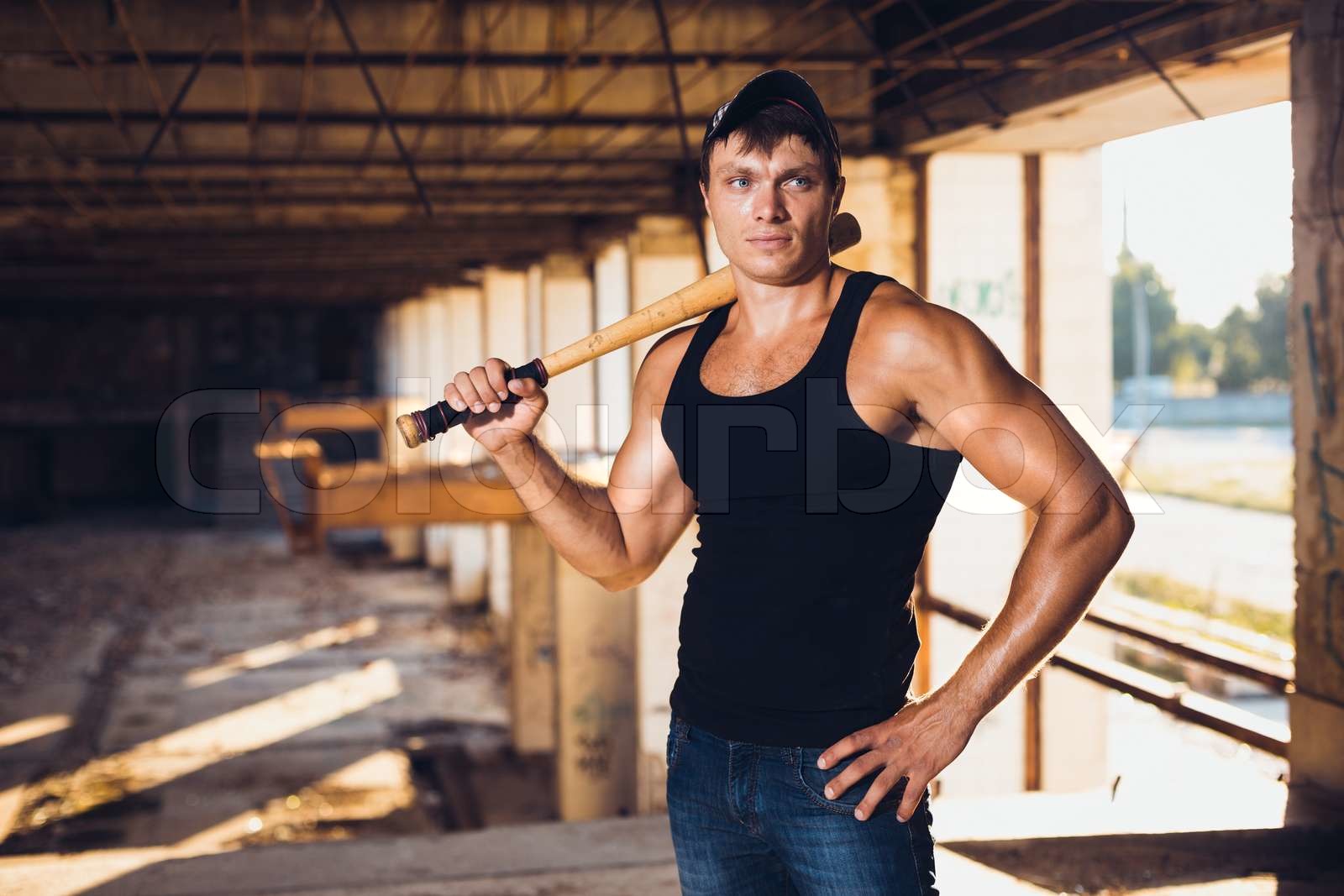 Muscular man with baseball bat | Stock image | Colourbox