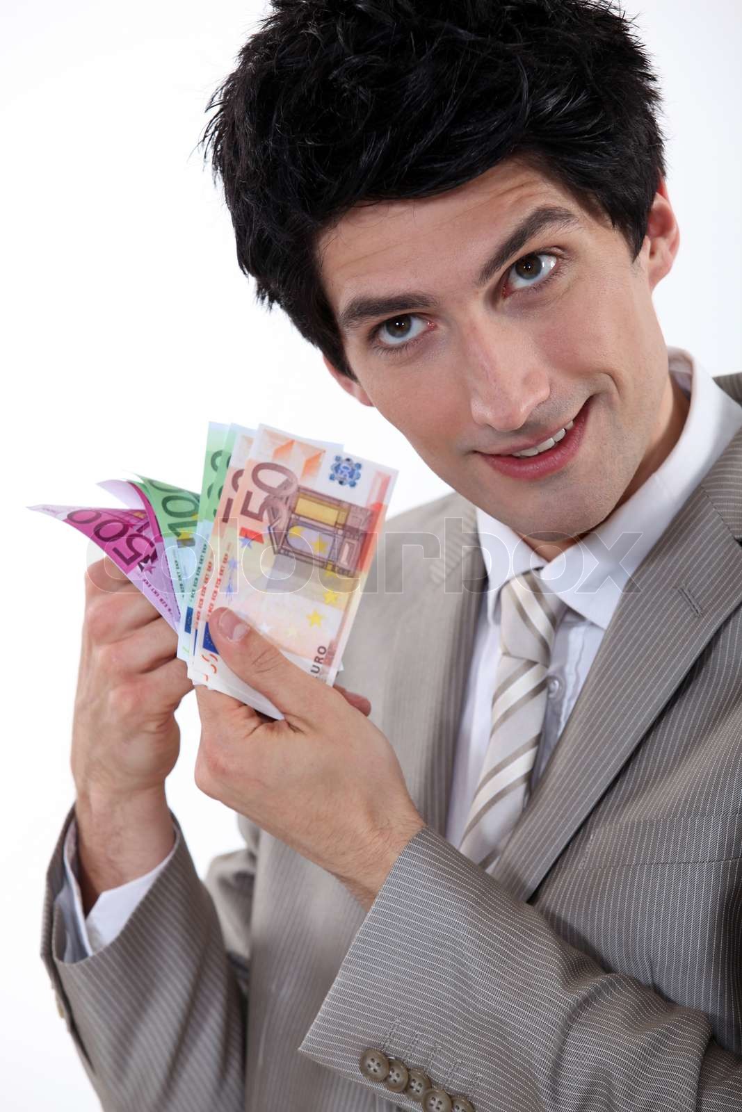 banker holding bank notes | Stock image | Colourbox