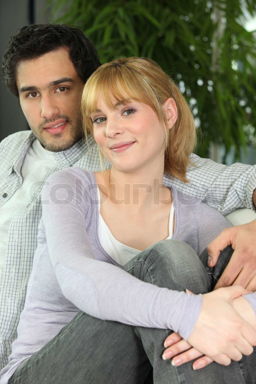 Couple sitting on sofa | Stock image | Colourbox