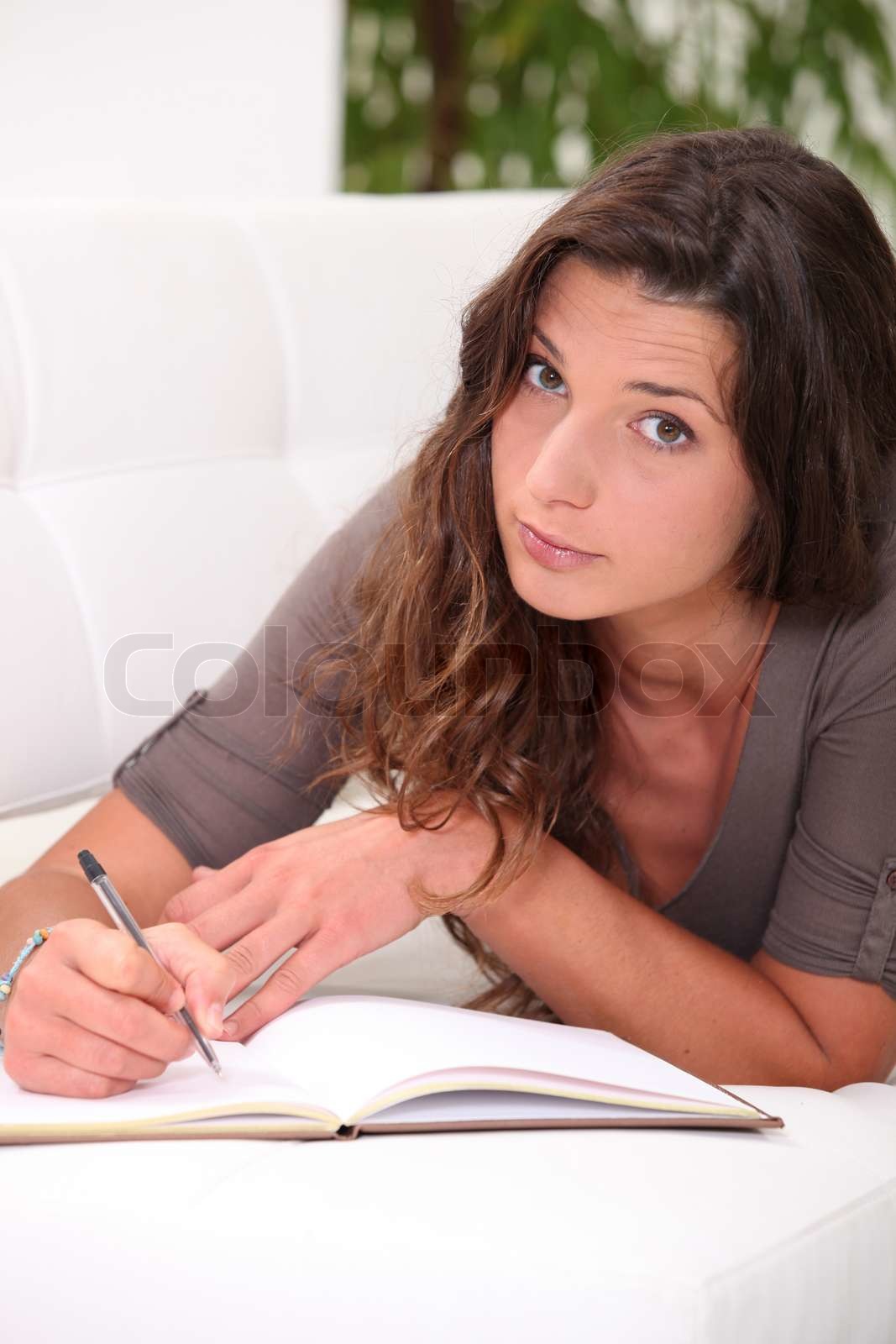 Woman writing in her journal | Stock image | Colourbox