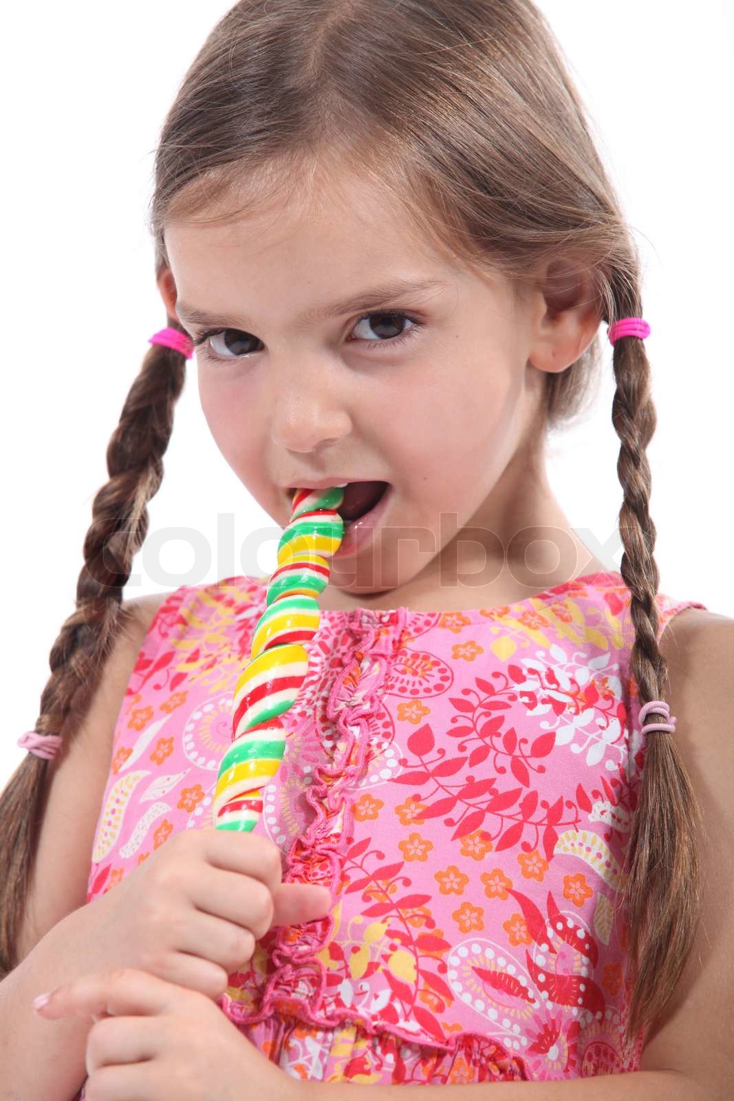 Girl eating a lolly pop | Stock image | Colourbox