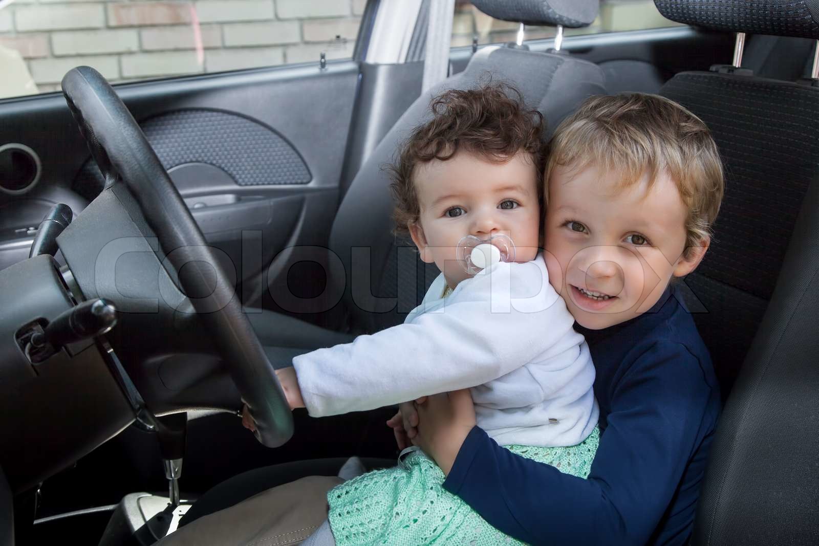 Children sit in the car | Stock image | Colourbox