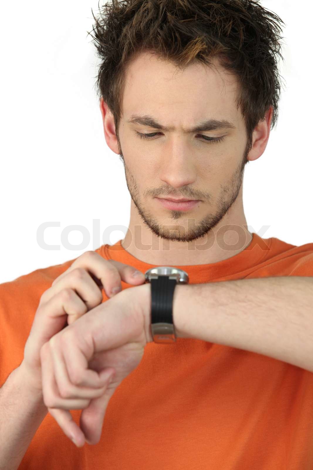 Man checking his wristwatch for the time | Stock image | Colourbox