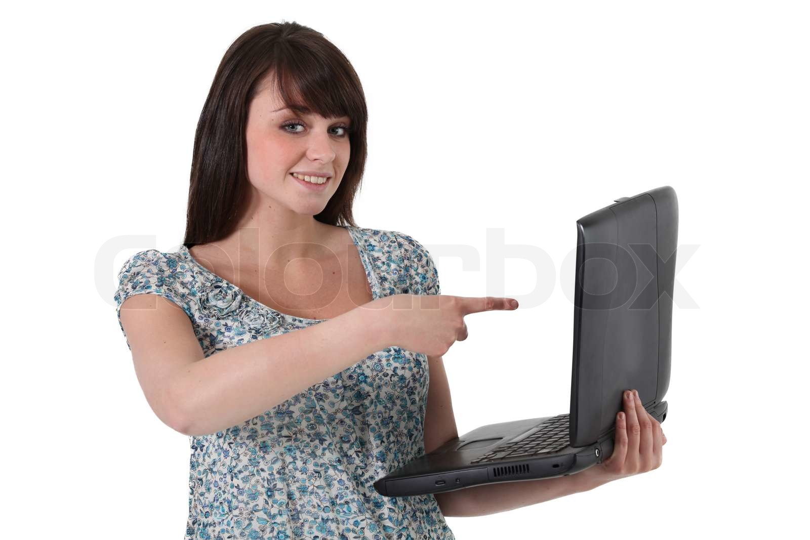 Woman pointing at a laptop | Stock image | Colourbox