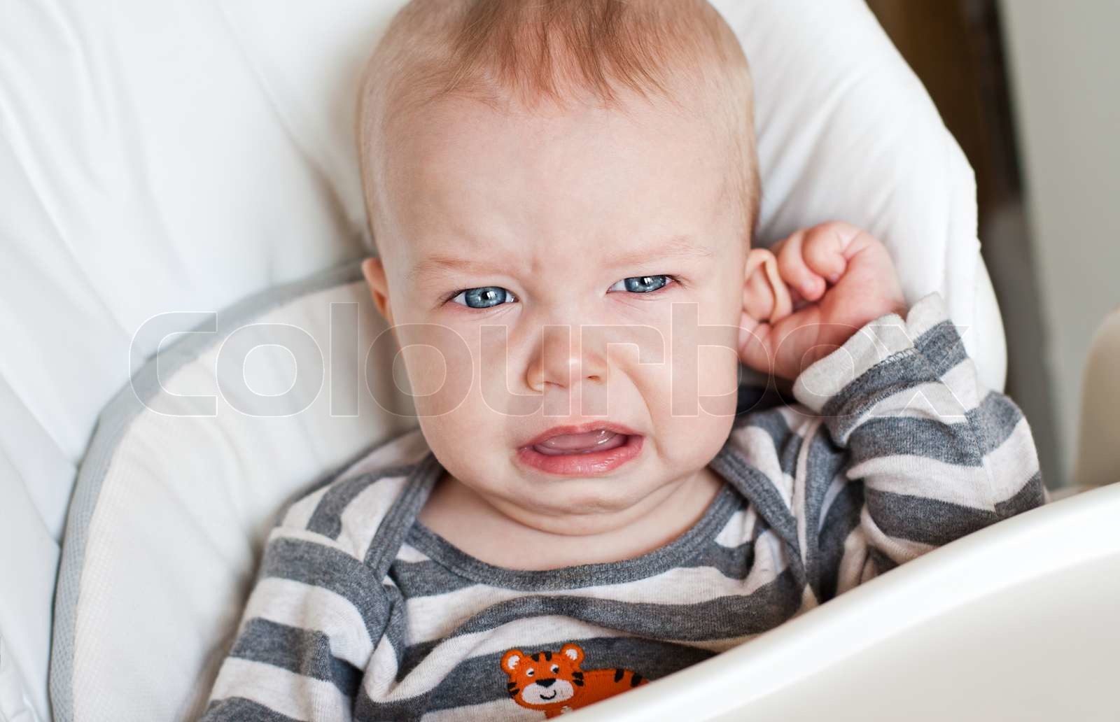 cute little boy crying holding his ear | Stock image | Colourbox