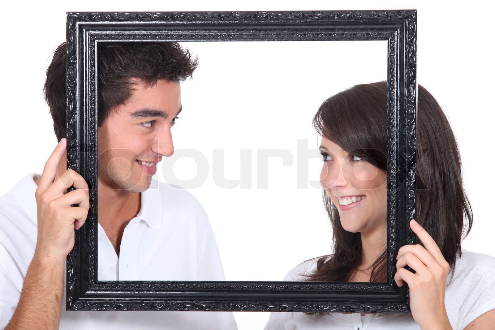 Young couple behind photo frame | Stock image | Colourbox