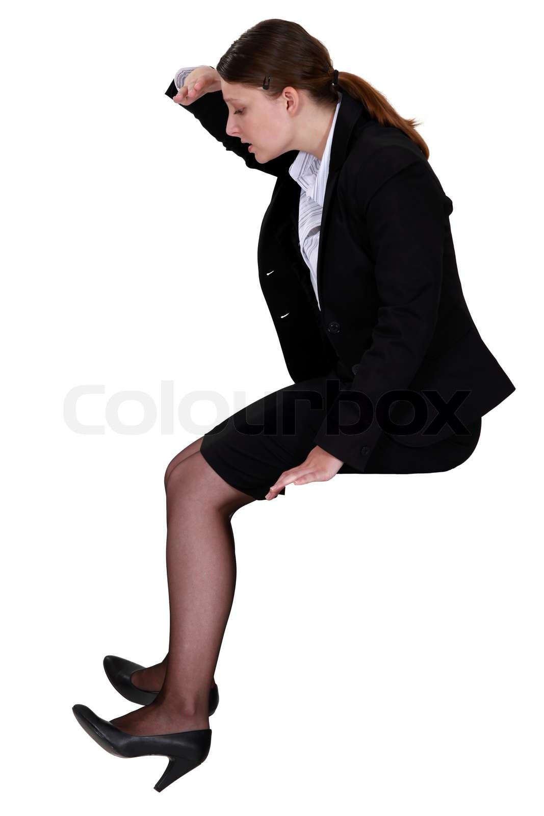 Woman sitting looking down | Stock image | Colourbox