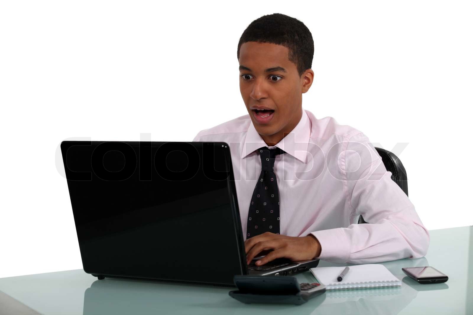 Young man aghast at his computer | Stock image | Colourbox