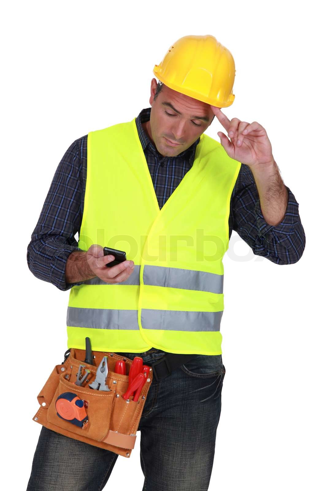 Construction worker sending text message | Stock image | Colourbox