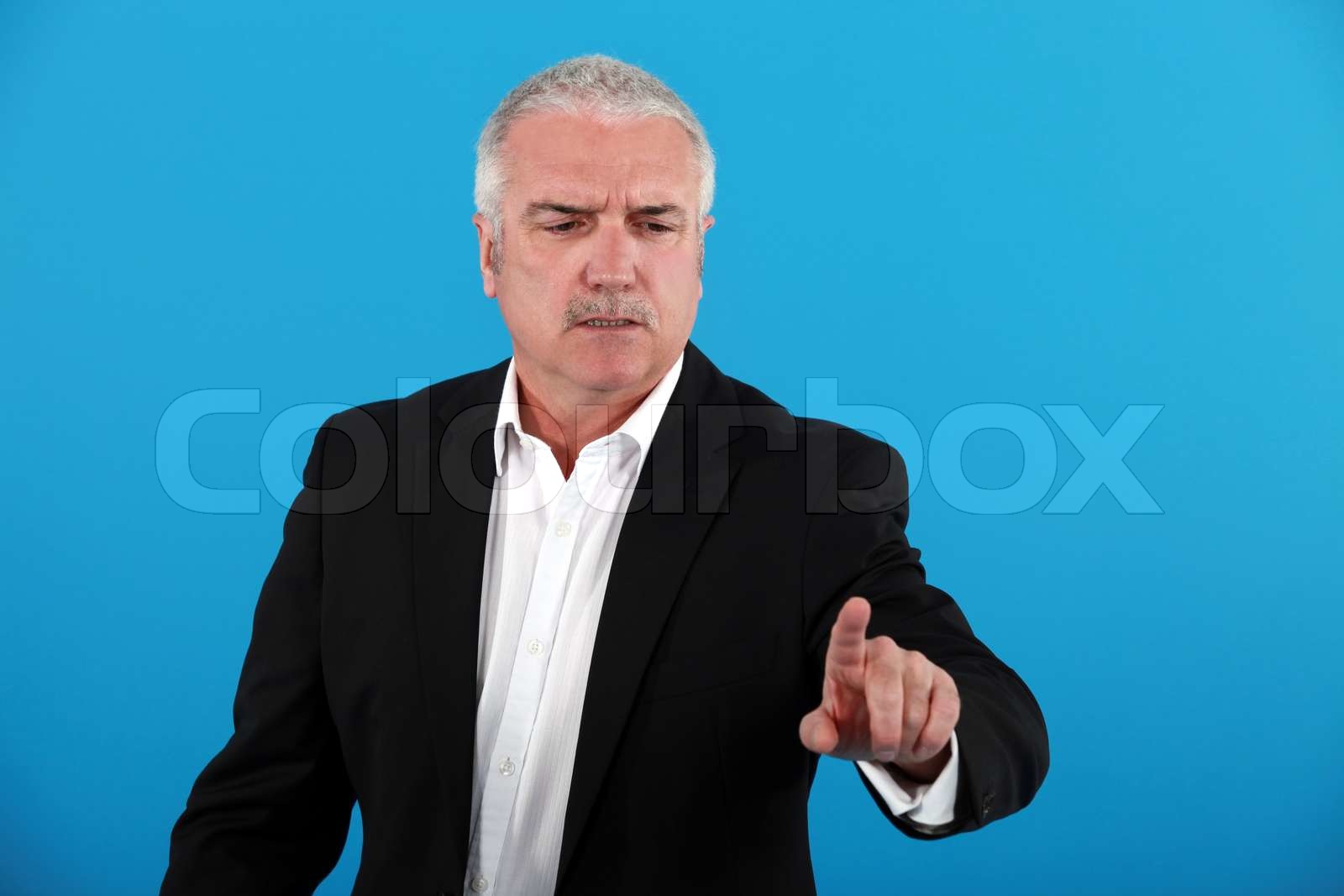 Stern businessman pointing | Stock image | Colourbox