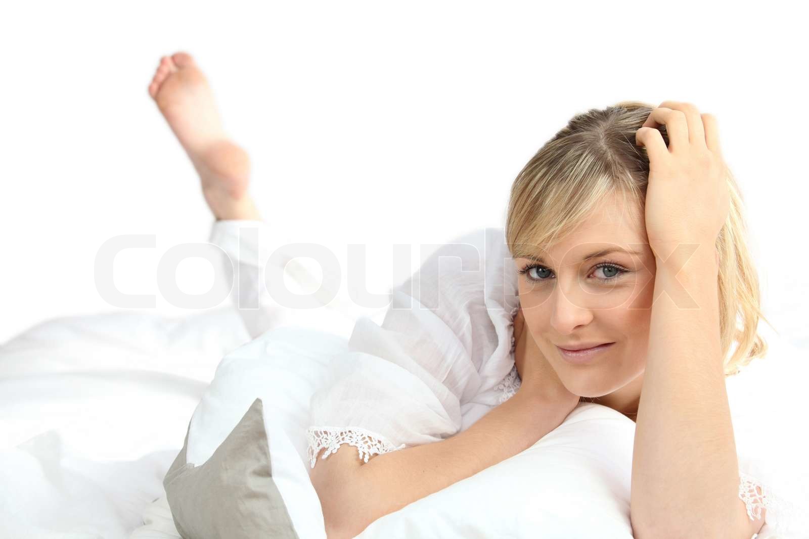 Woman laid on her bed | Stock image | Colourbox