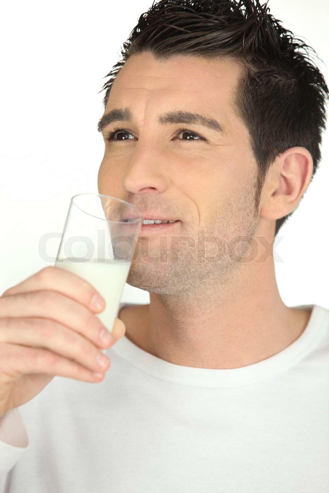 Man drinking glass of milk | Stock image | Colourbox