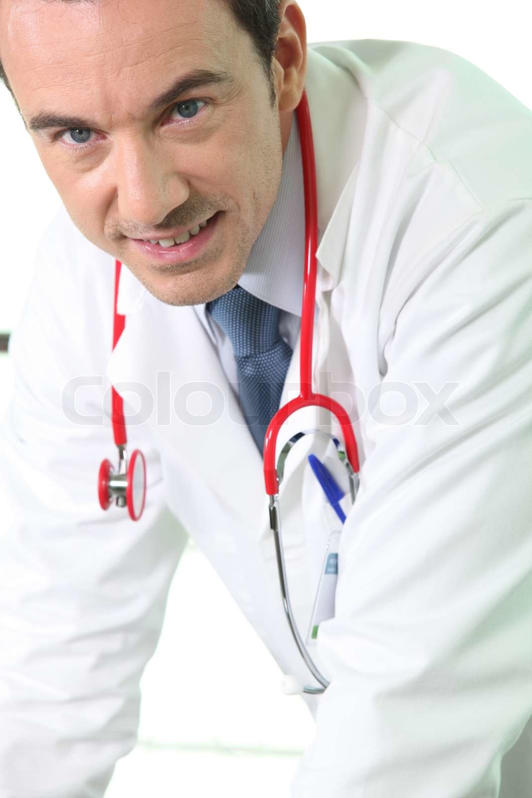 Doctor stooping over | Stock image | Colourbox