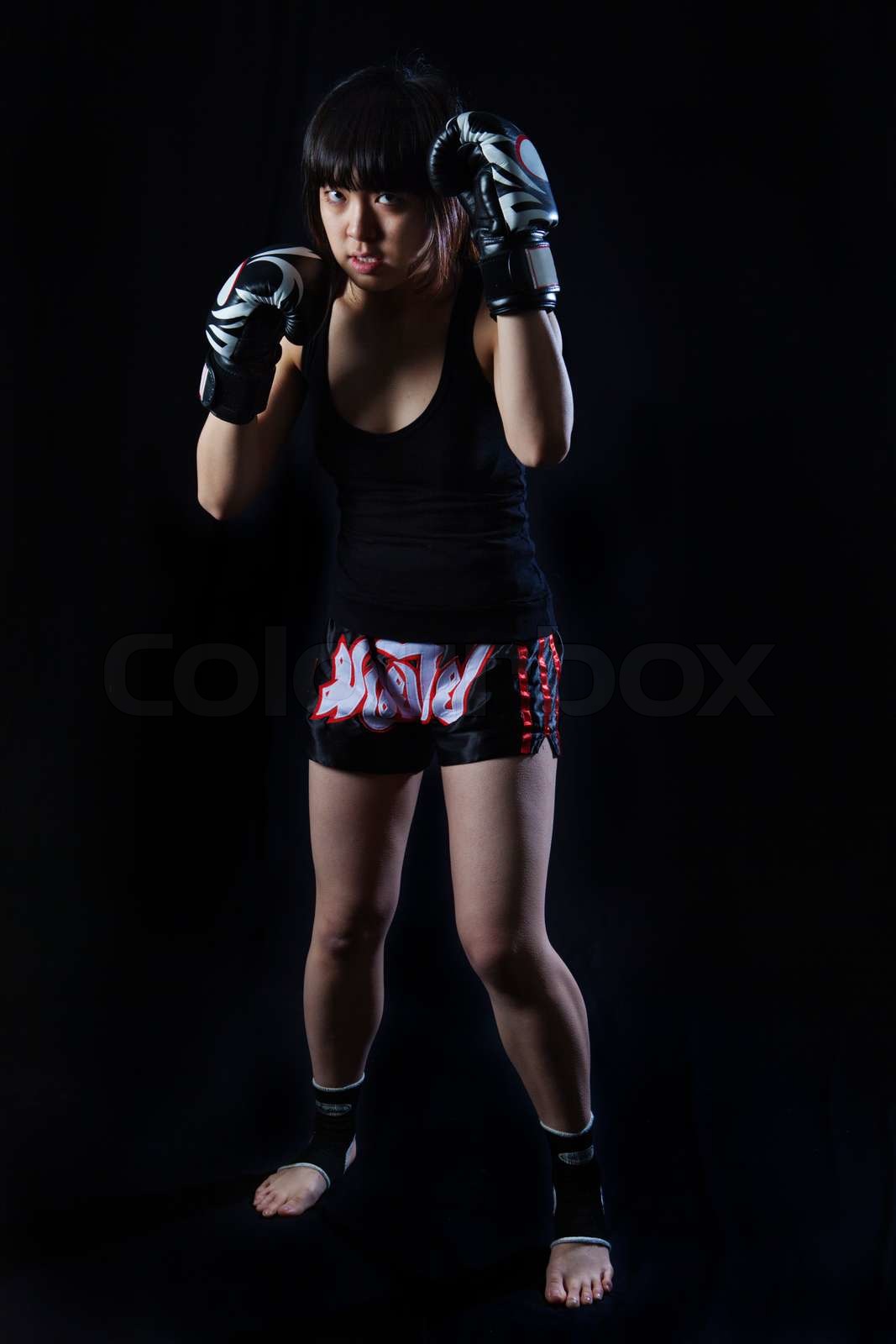 Young Asian Woman Muay Thai fighter in defensive position | Stock image ...