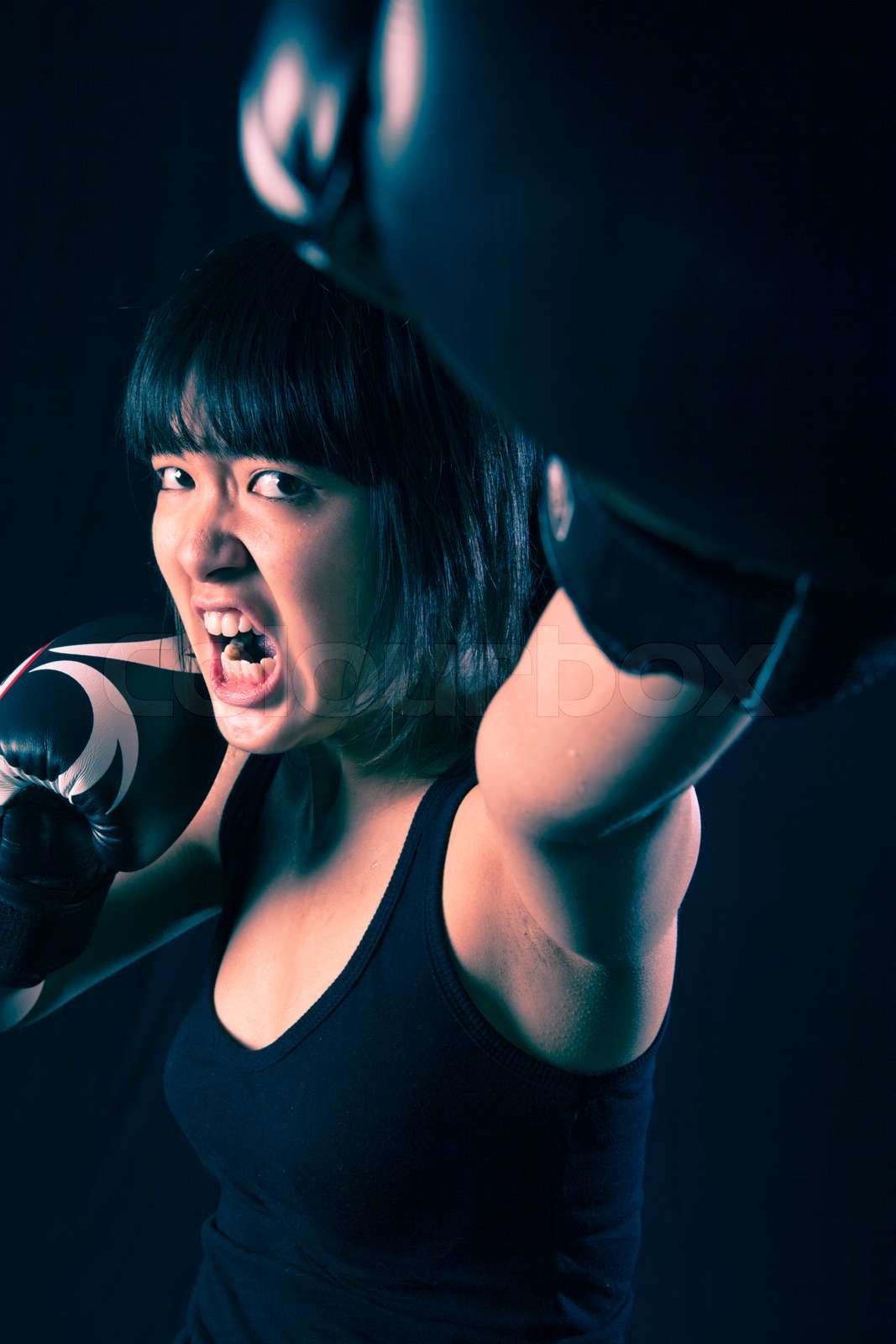 Young asian girl punching to camera | Stock image | Colourbox