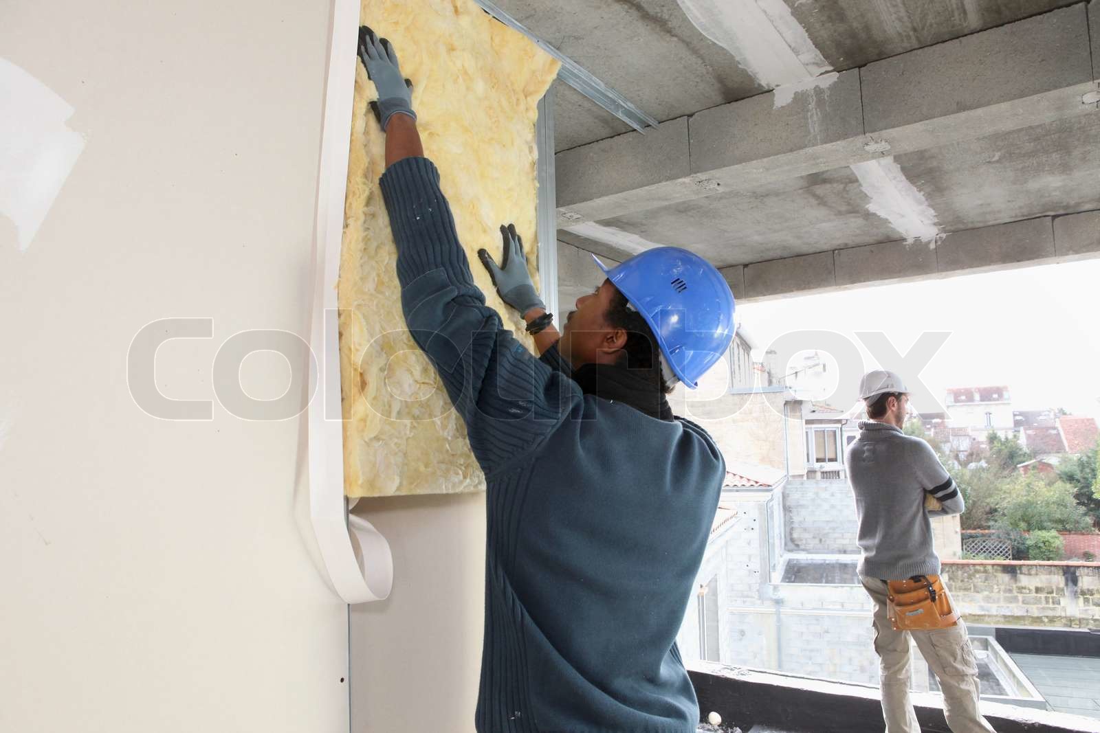 craftsman insulating a wall | Stock image | Colourbox