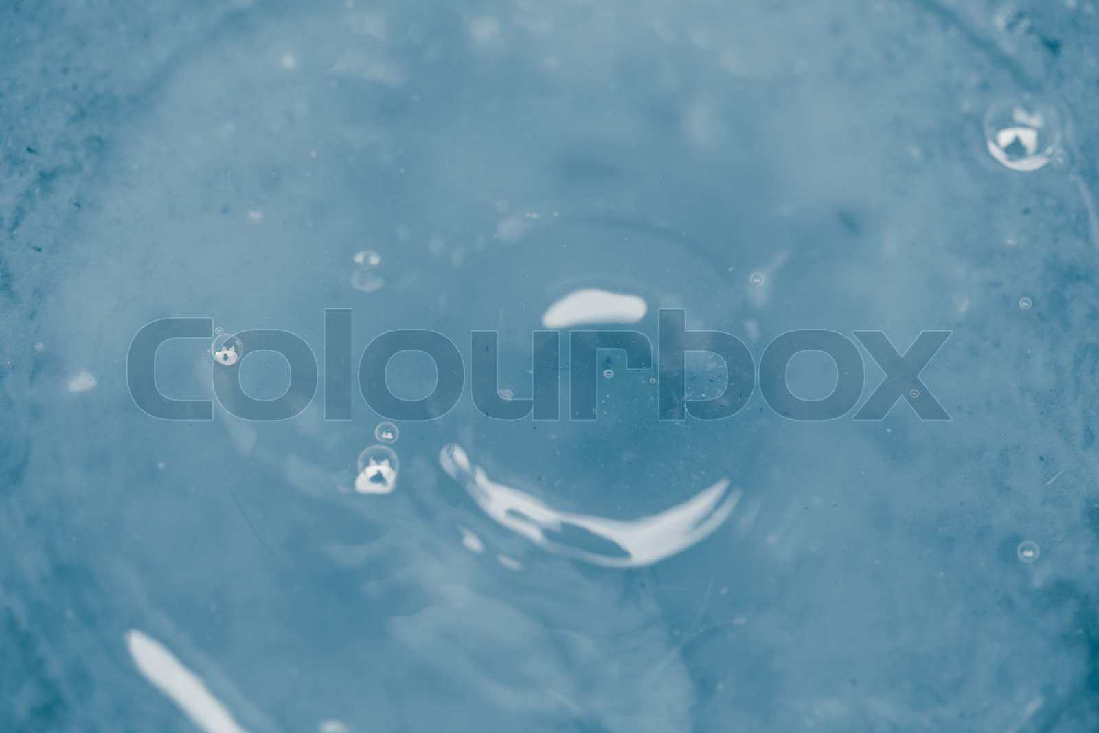 drops of water dripping into a puddle | Stock image | Colourbox