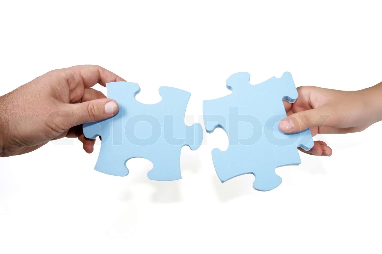 Man and woman joining puzzle | Stock image | Colourbox