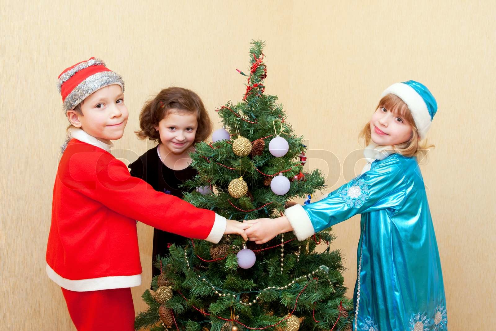 Children dancing around the Christmas tree | Stock image | Colourbox