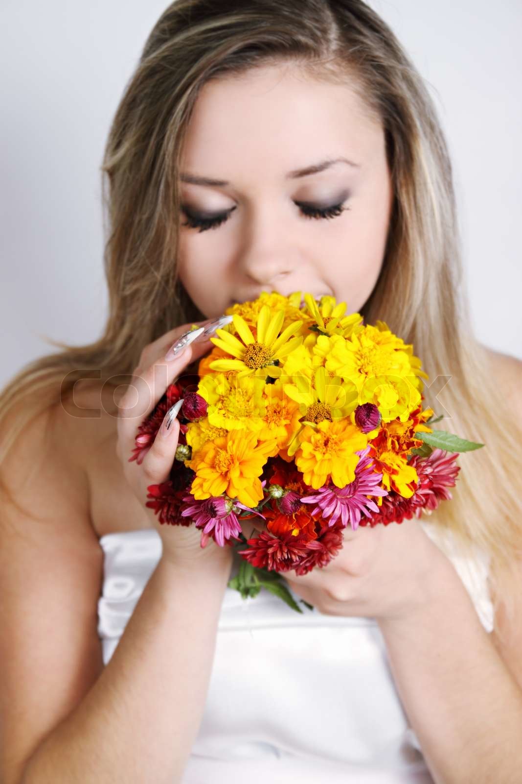 woman smelling a bouquet | Stock image | Colourbox