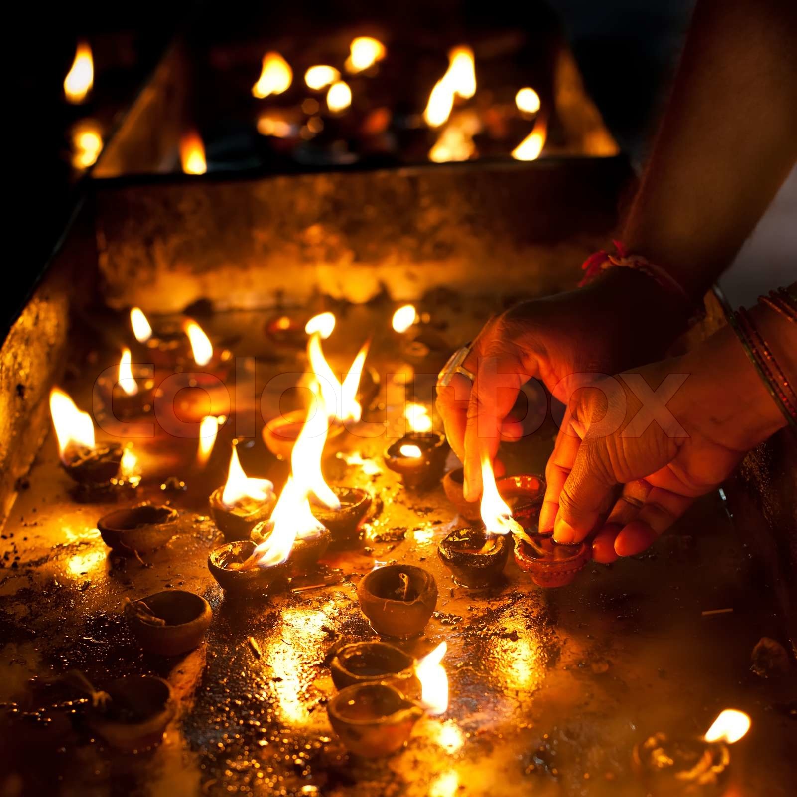 People burning oil lamps as religious ritual in Hindu temple India ...