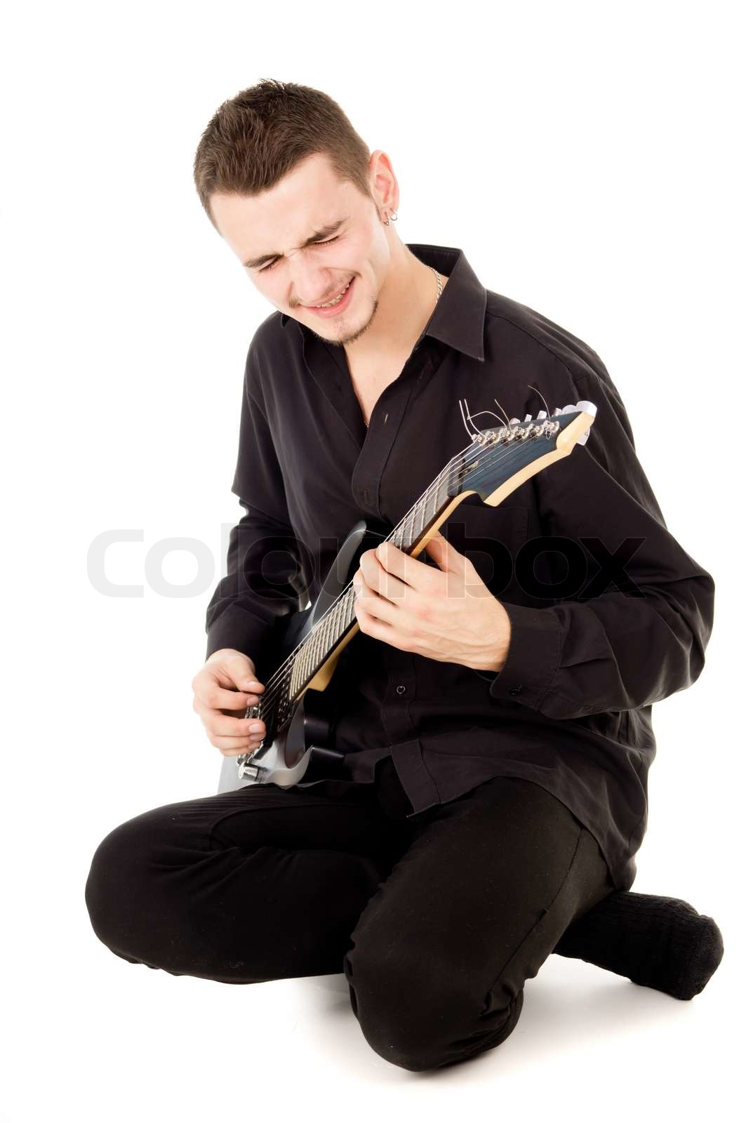 mischievous guy plays the electric guitar | Stock image | Colourbox