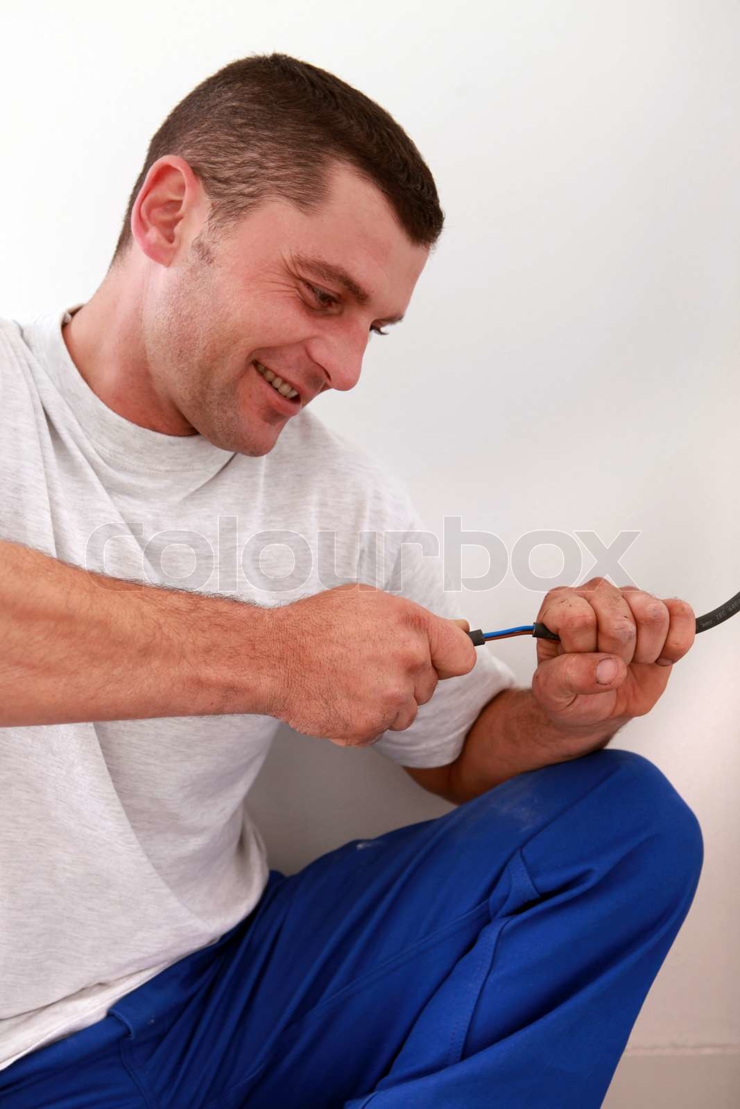 Man pulling cable | Stock image | Colourbox