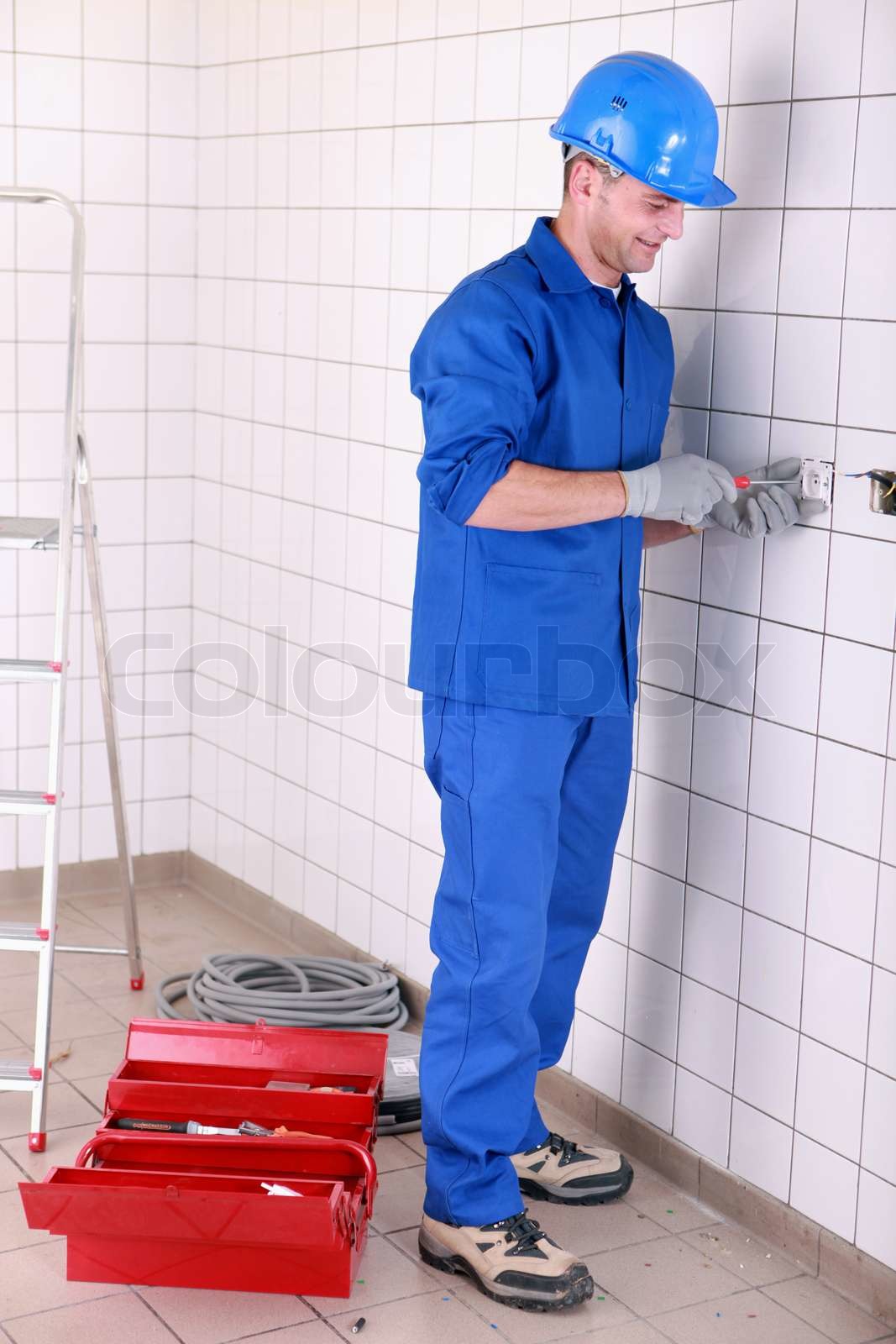Man fitting an electric socket | Stock image | Colourbox